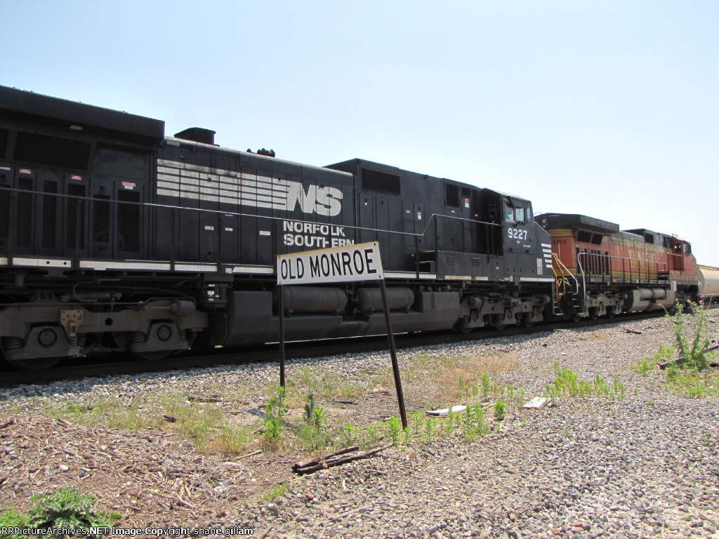 NS 9227 trails a bnsf dash 9 on a freight train.